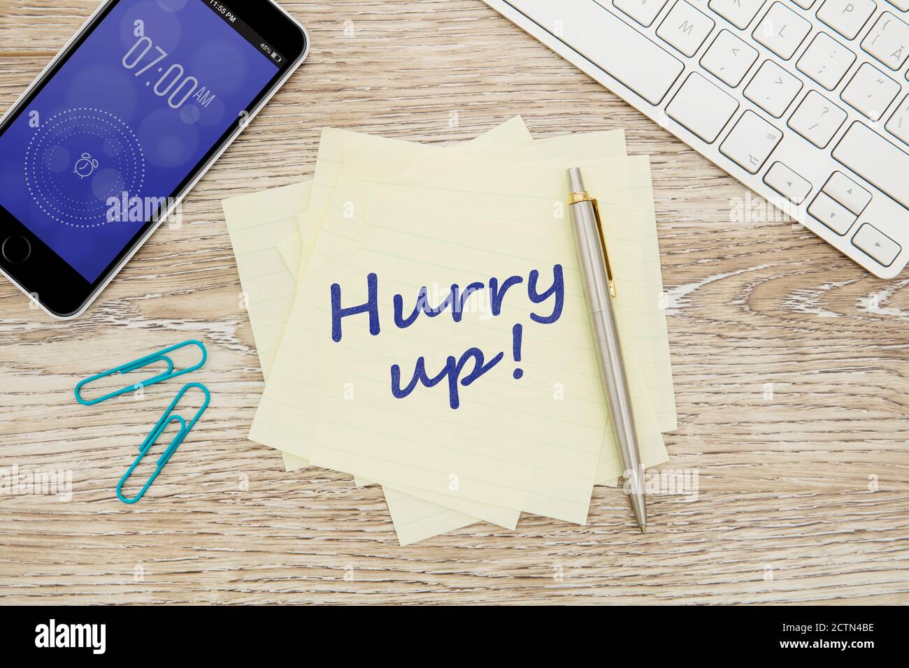 Hurry up message on adhesive note on office table Stock Photo - Alamy