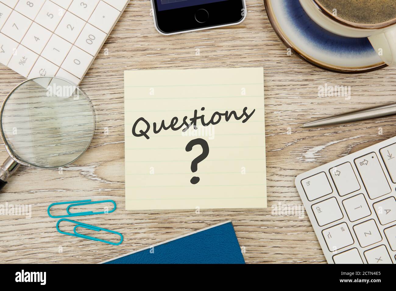 Adhesive notes with questions message on desk Stock Photo - Alamy