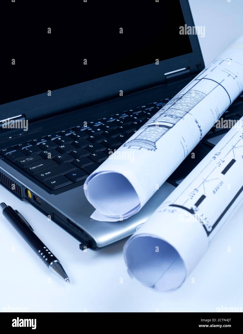Blueprints, pen and laptop Stock Photo - Alamy