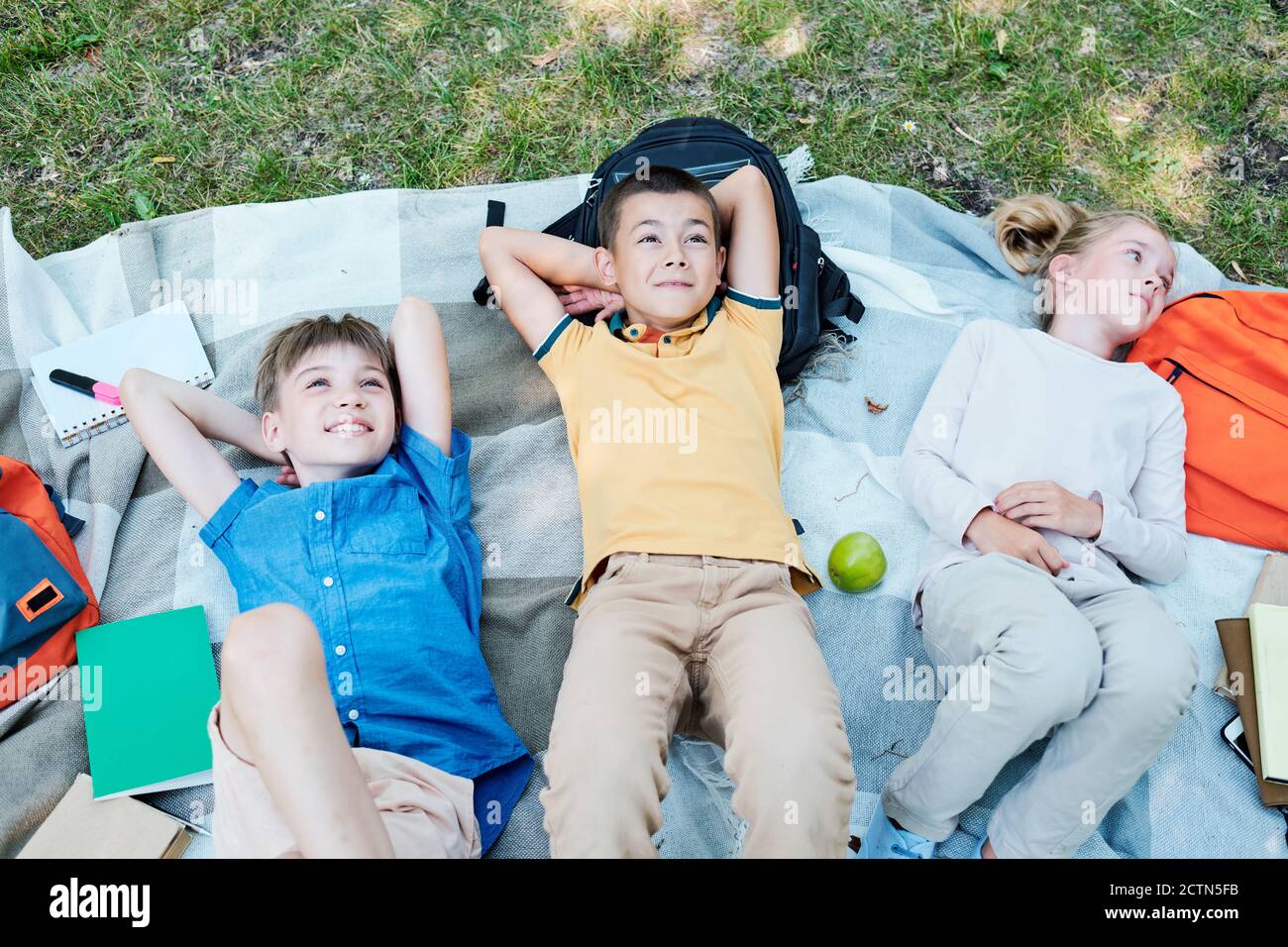 School girls lying on grass hi-res stock photography and images - Alamy