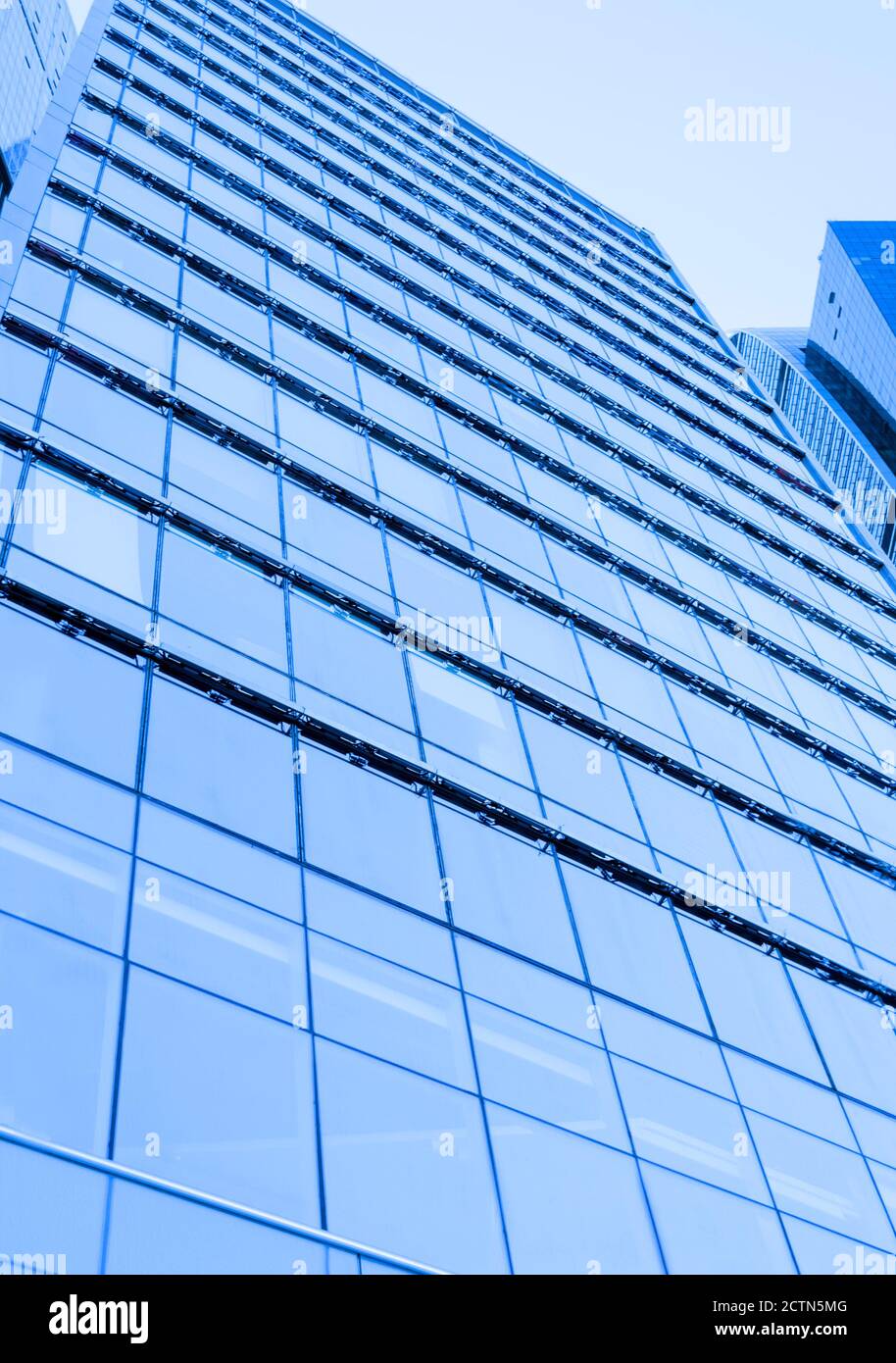 Perspective wide angle view to steel light blue glass surface, building ...