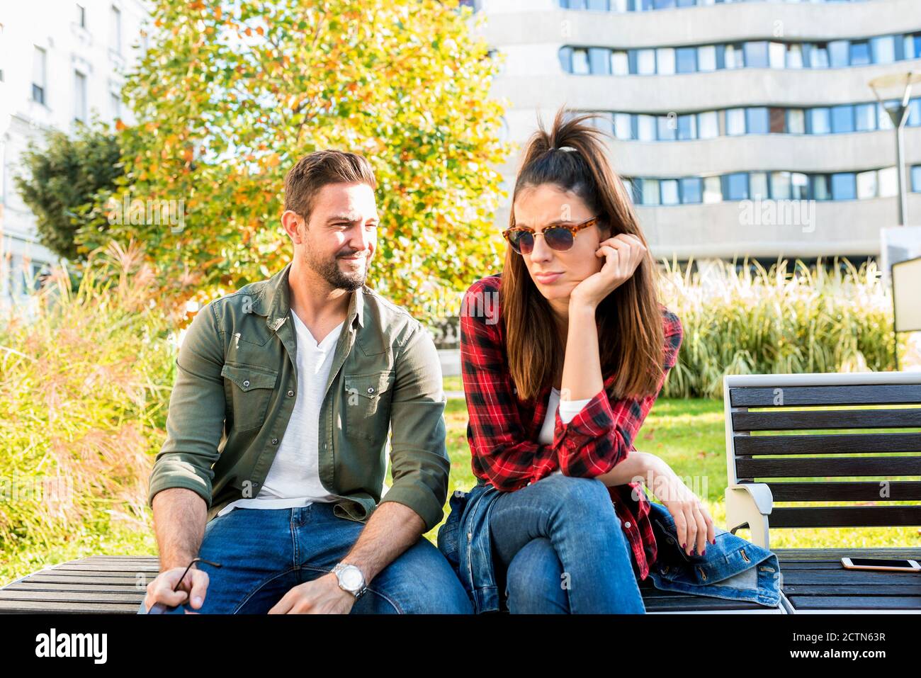 A girlfriend being annoyed by her boyfriend on a sunny day on a park ...