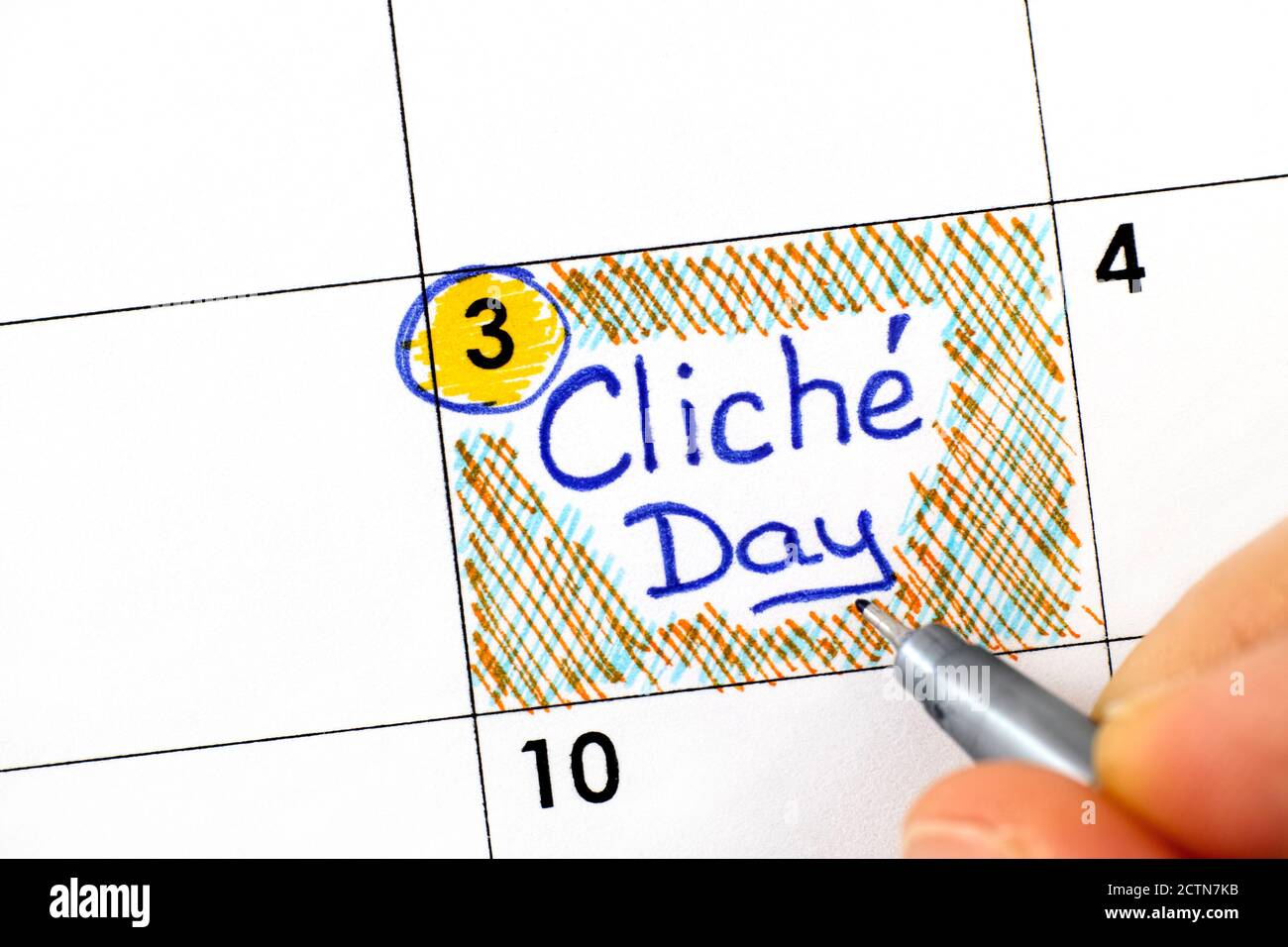 Woman fingers with pen writing reminder Cliche Day in calendar ...