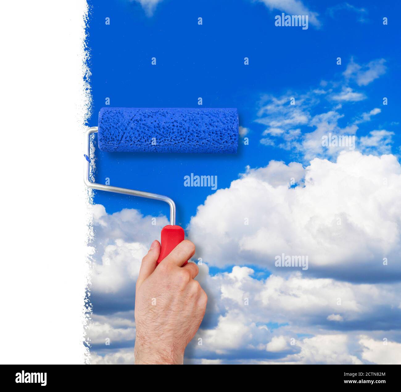 Hand with paintbrush painting the wall with sky texture, isolated on ...