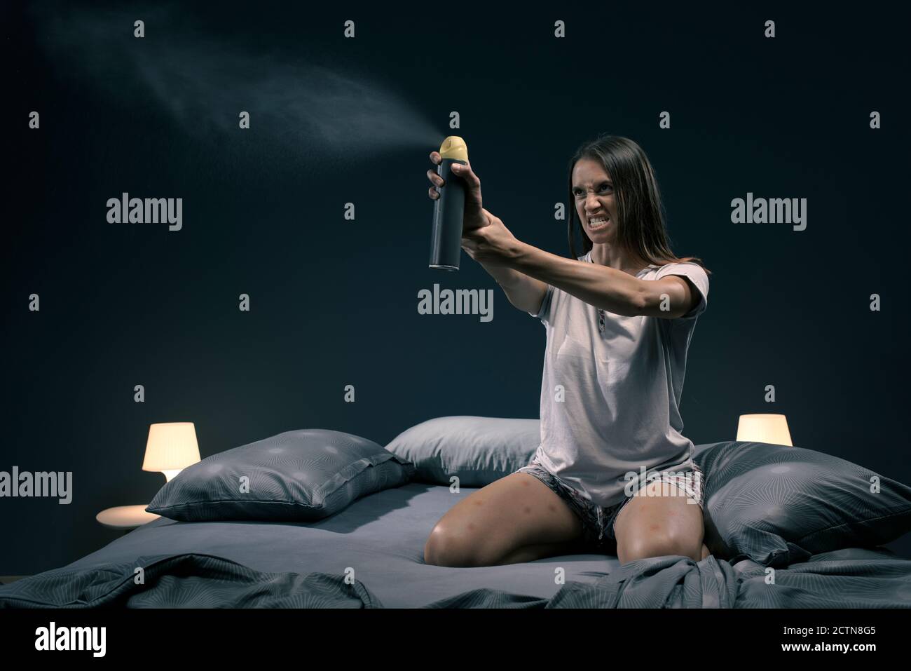 Woman using insecticide spray hi-res stock photography and images - Alamy