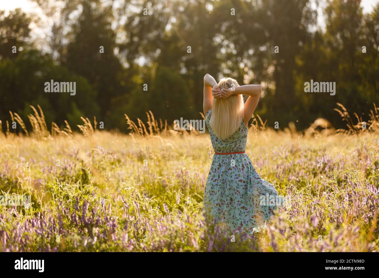 Healthy beautiful woman walking outdoors. Alluring young woman in wheat ...