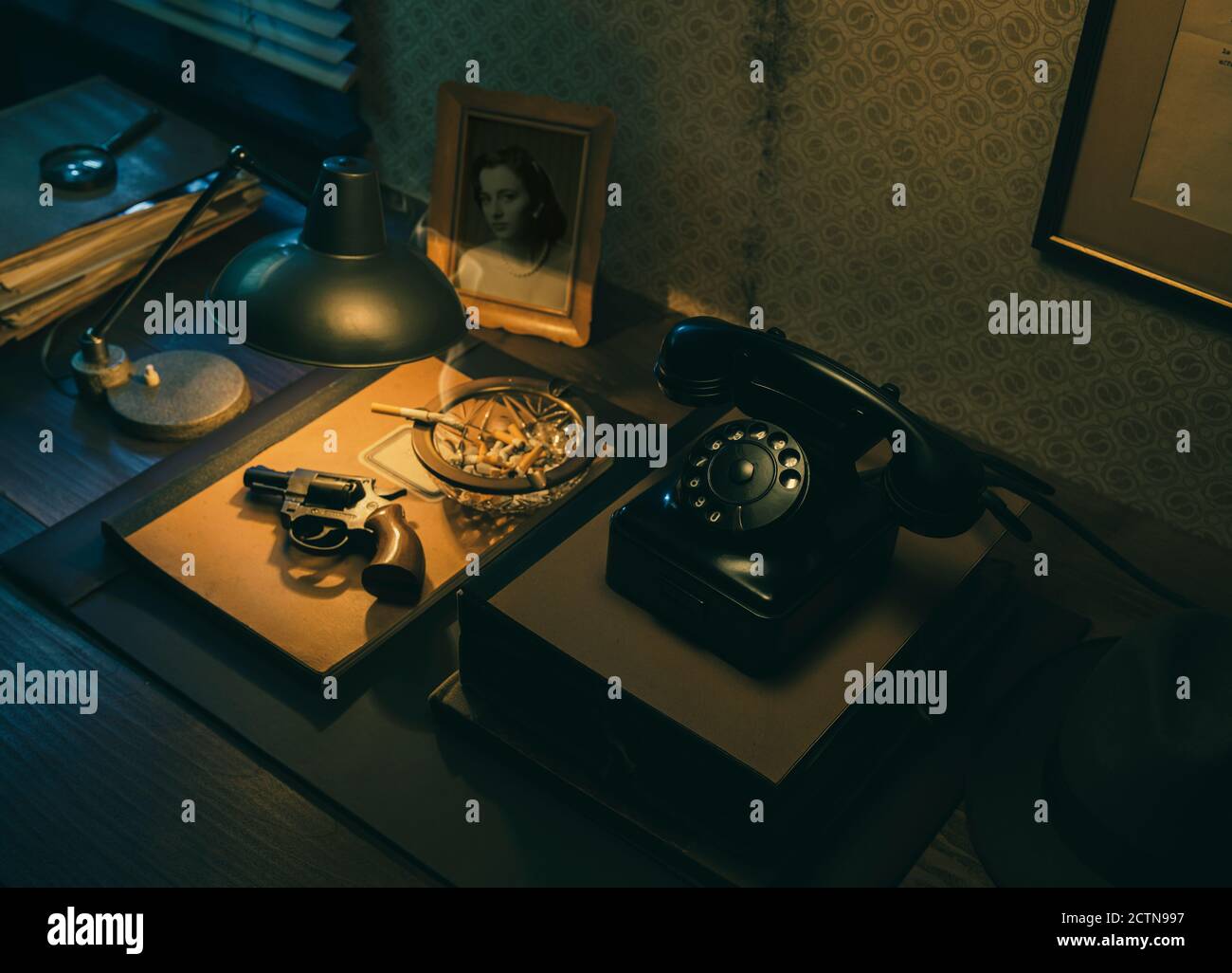 Film noir detective desktop with revolver, whiskey and ashtray ...