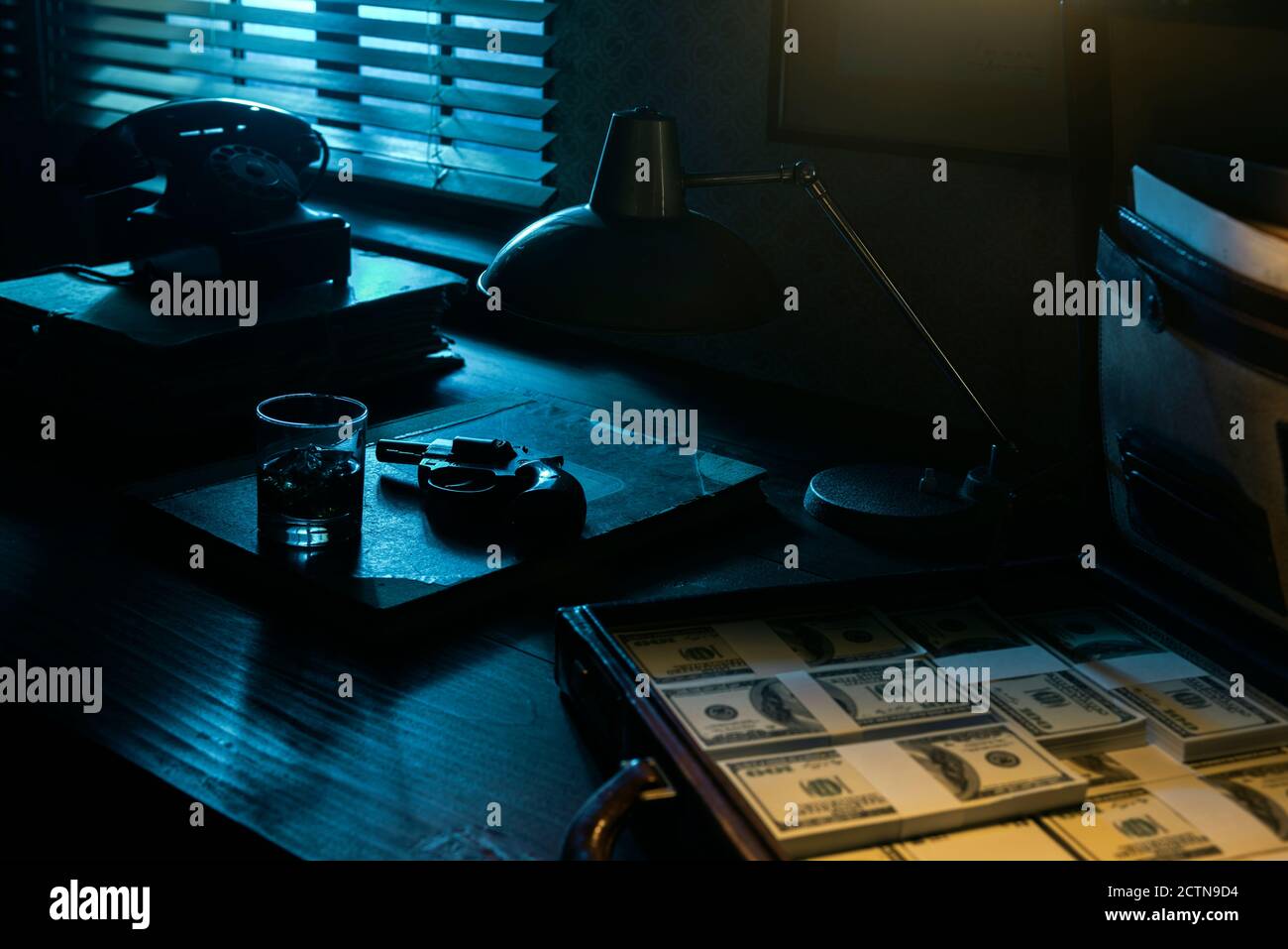 Vintage film noir style desktop with revolver, drink and open briefcase ...