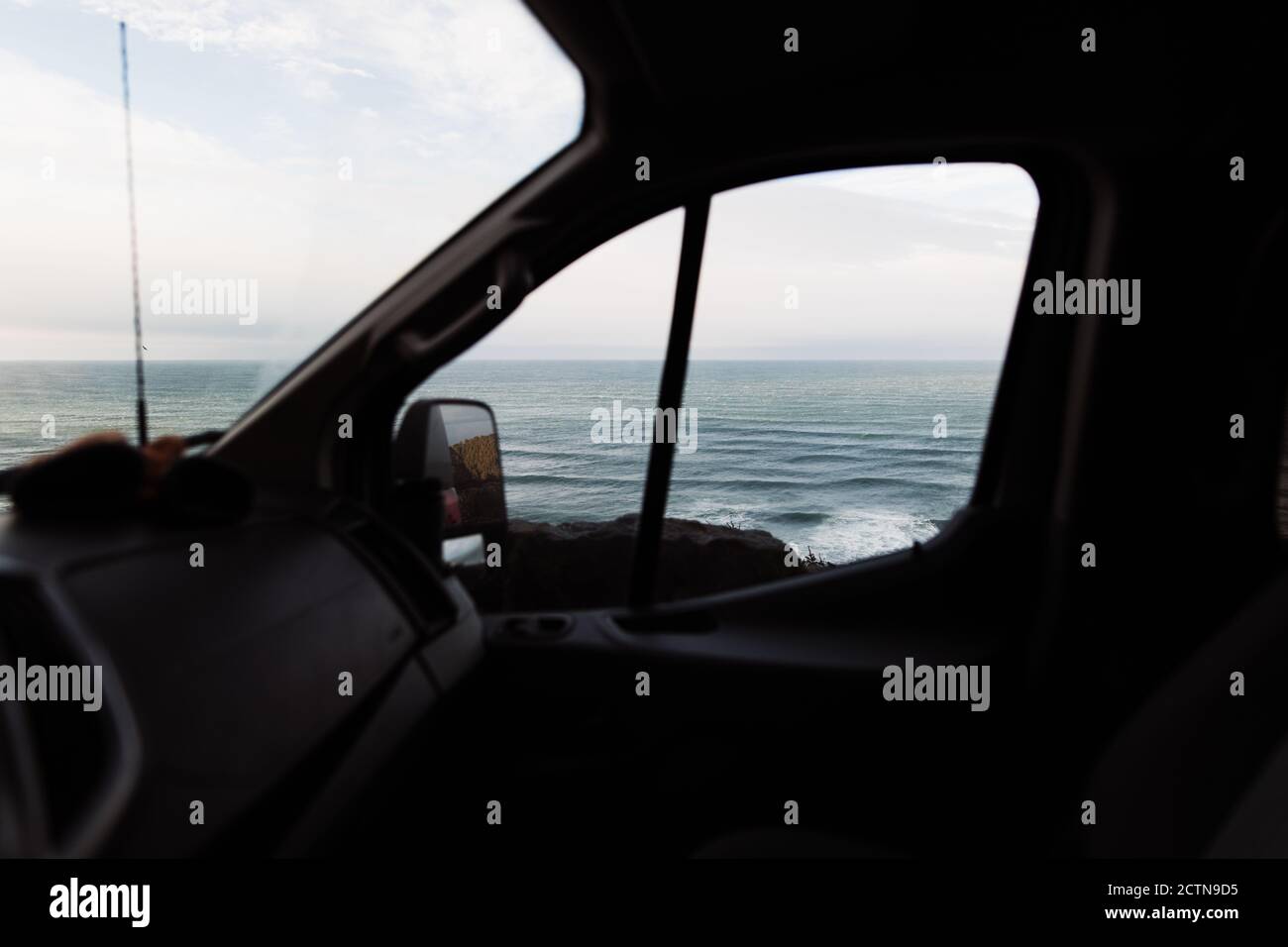 Through car window of spectacular scenery of sea with calm water under ...