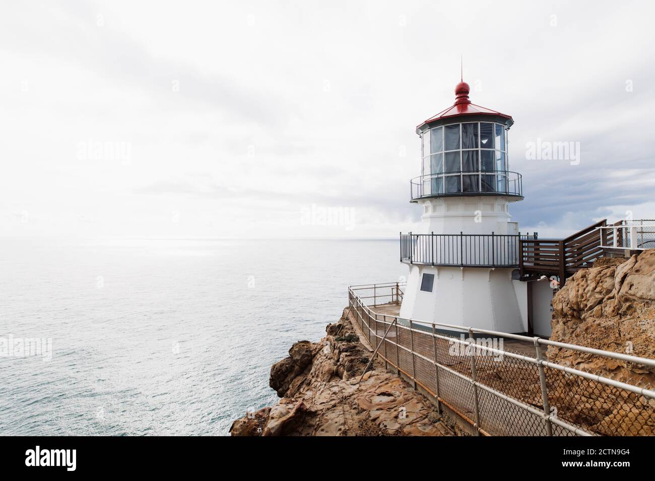 Breathtaking scenery of lighthouse and cabin located on rough rocky ...