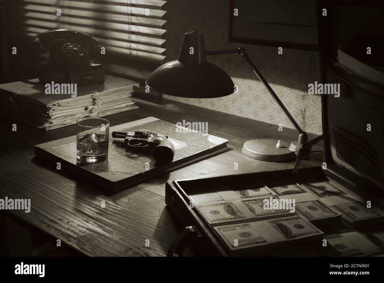 Vintage film noir style desktop with revolver, drink and open briefcase ...