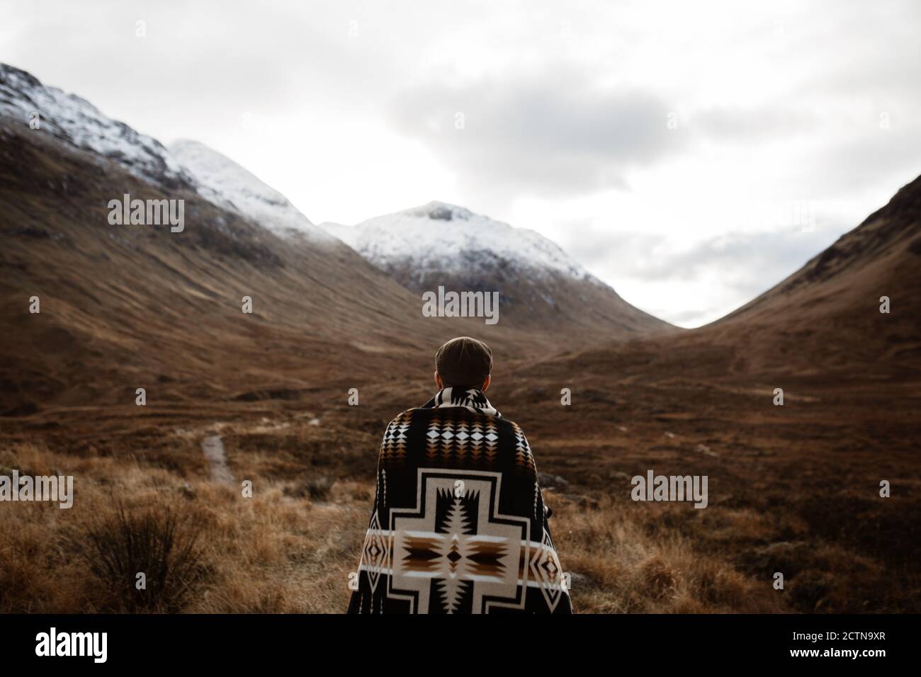 Back view of unrecognizable male explorer standing enjoying scenery of ...
