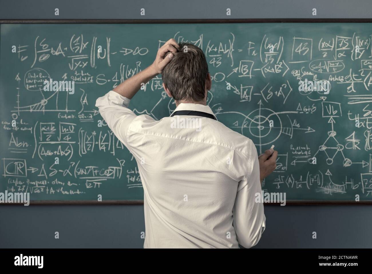 Young mathematician writing formulas on hi-res stock photography and ...