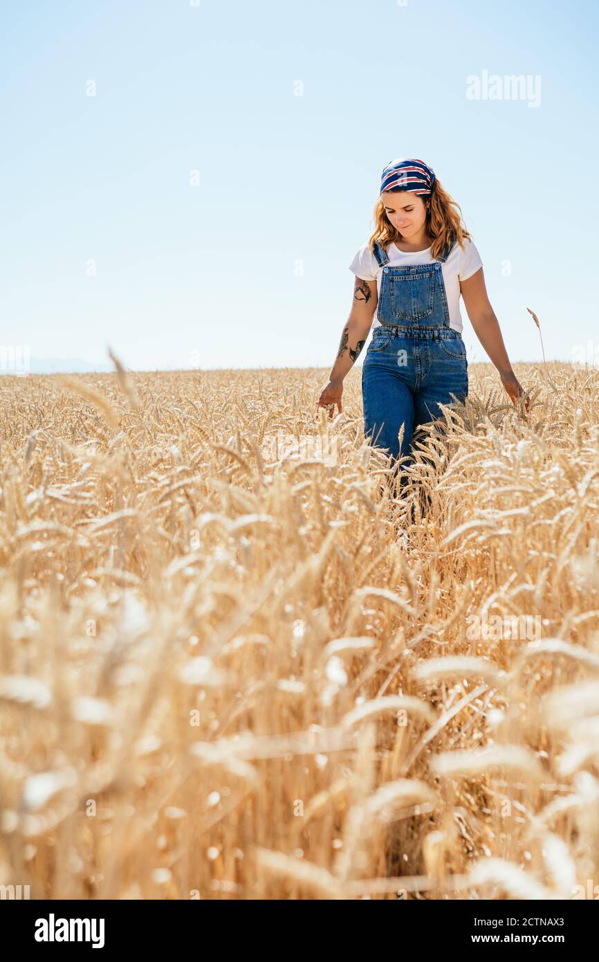 Woman in overalls walking field hi-res stock photography and images - Alamy