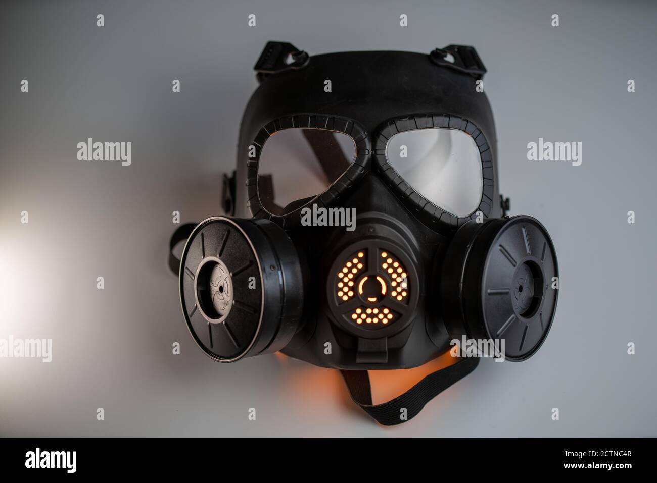 black gas mask with orange light Stock Photo - Alamy