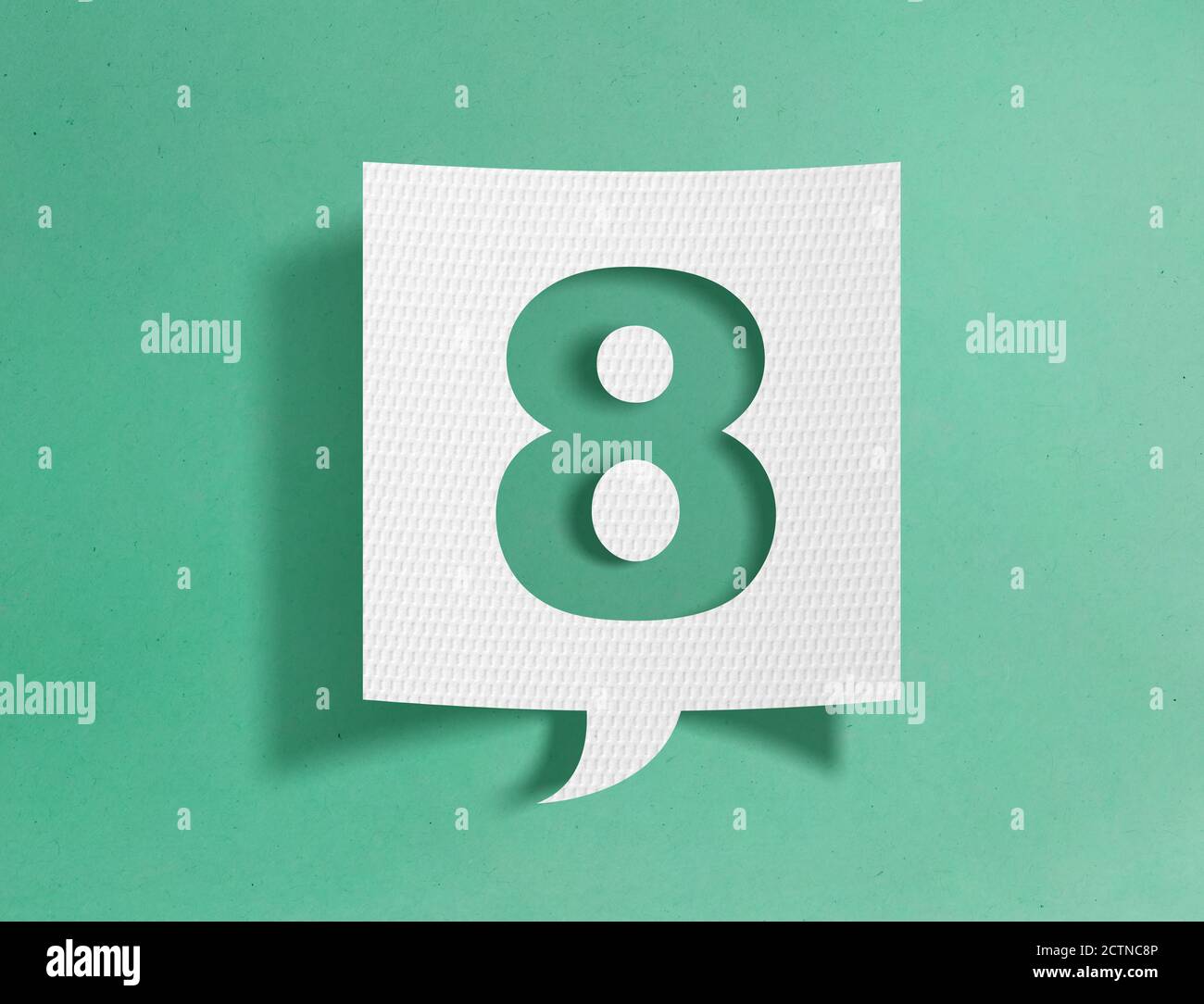 Speech bubble with number 8 on green background Stock Photo - Alamy