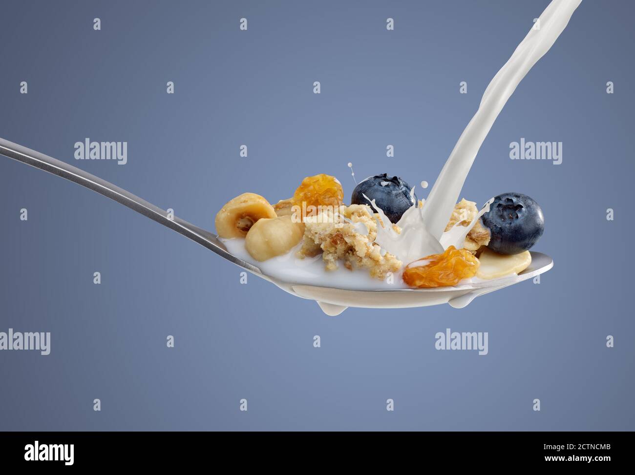 Breakfast cereal on a spoon with milk pouring Stock Photo - Alamy