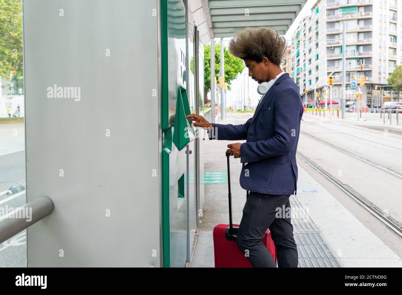 Black man with afro hair pulling out a ticket on the tram with a ...