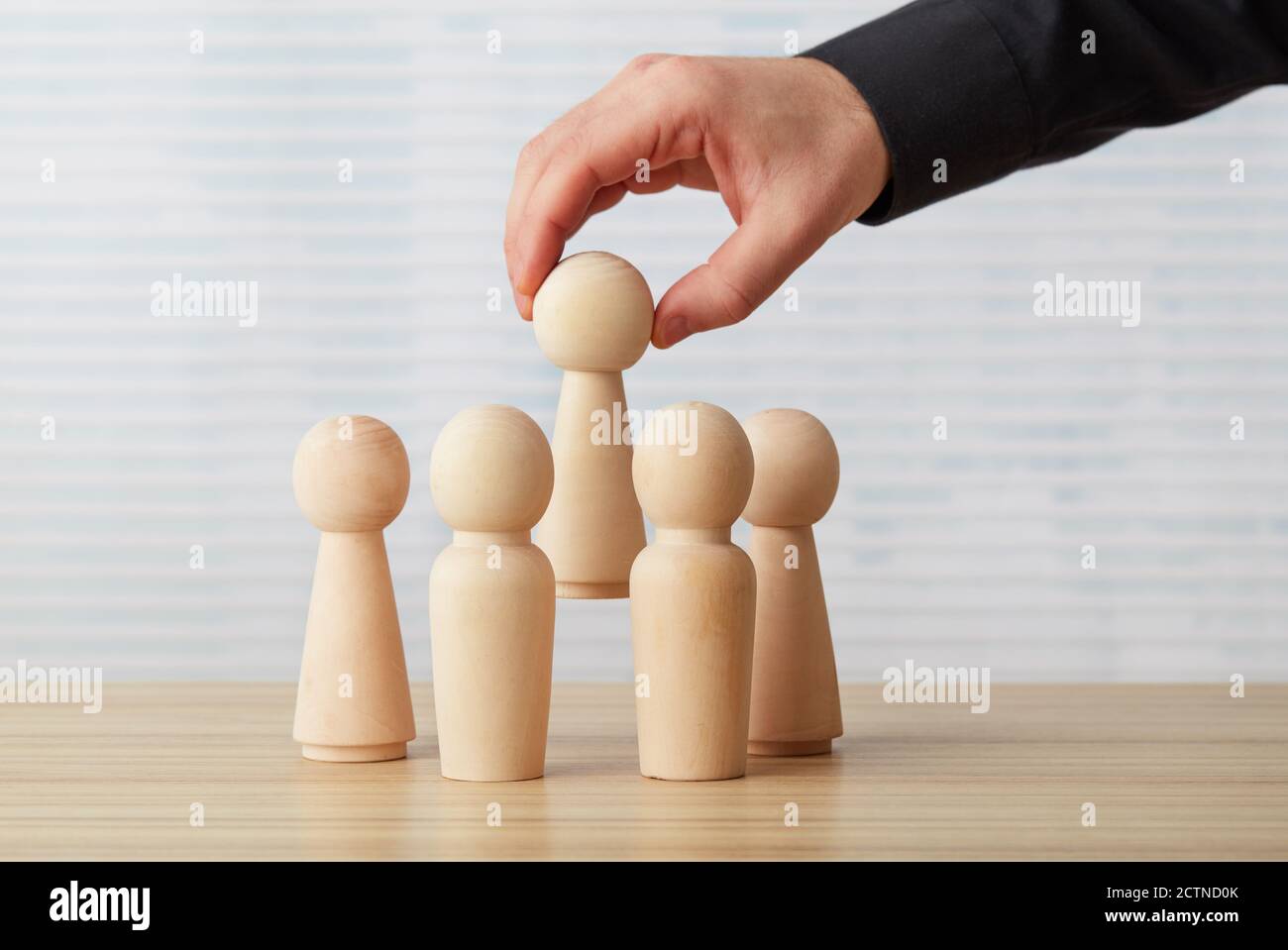Wooden people figures on desk table Stock Photo - Alamy