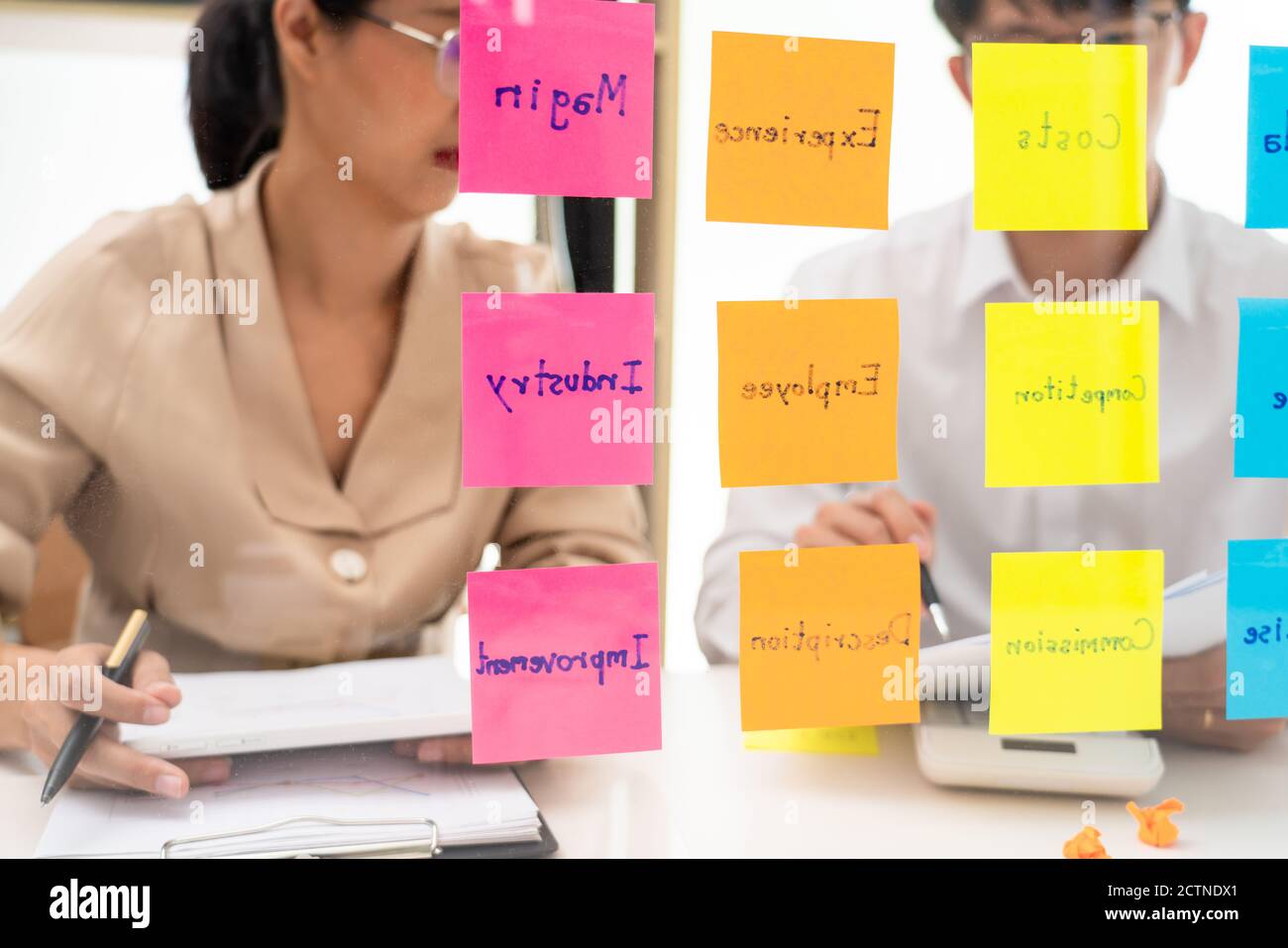 business people planning startup project placing sticky notes session ...