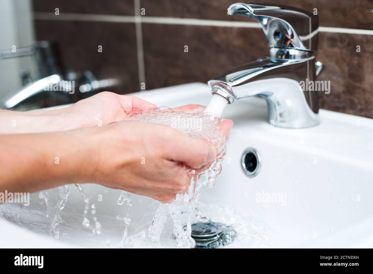 Washing hands under the water tap or faucet without soap. Hygiene ...