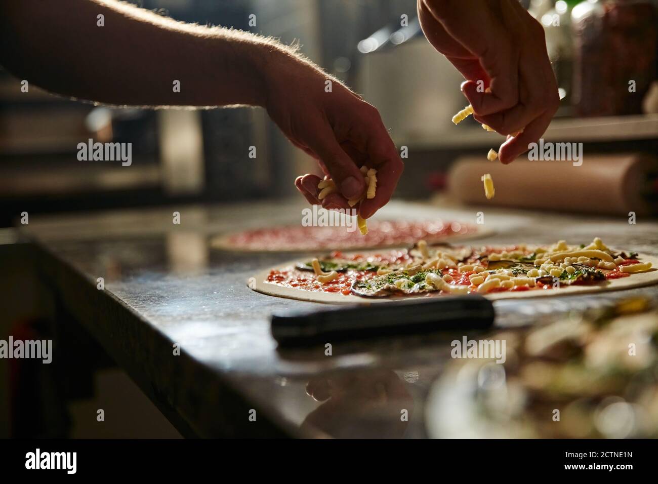 Process of preparation pizza with various vegetables on marble counter ...
