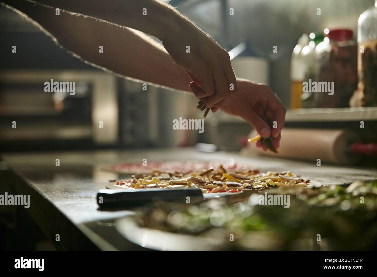 Process of preparation pizza with various vegetables on marble counter ...