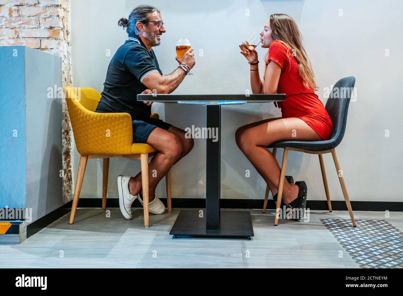 Couple sitting side by side at table hi-res stock photography and ...