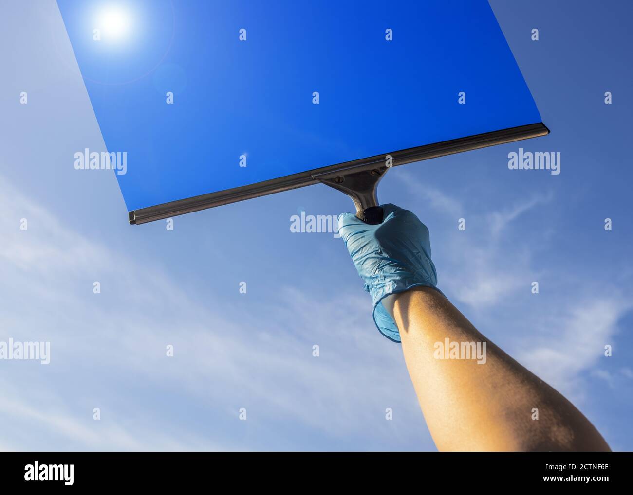 Person with a glove and rubber scraper for cleaning windows Stock Photo ...