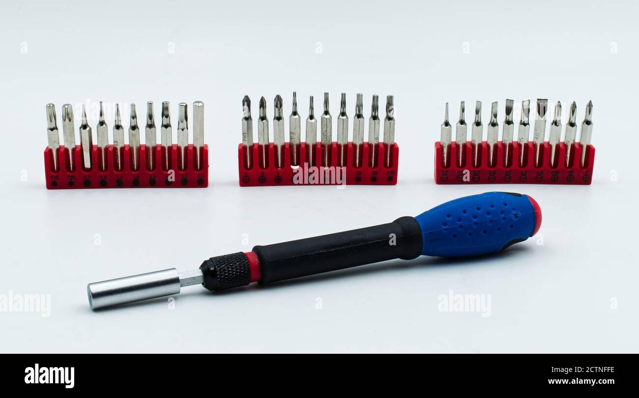 Screwdriver with bit set isolated on white background Stock Photo - Alamy