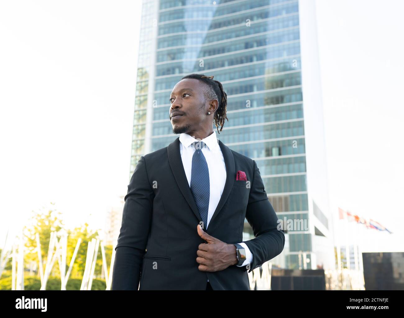 Serious African American male entrepreneur wearing elegant suit walking ...