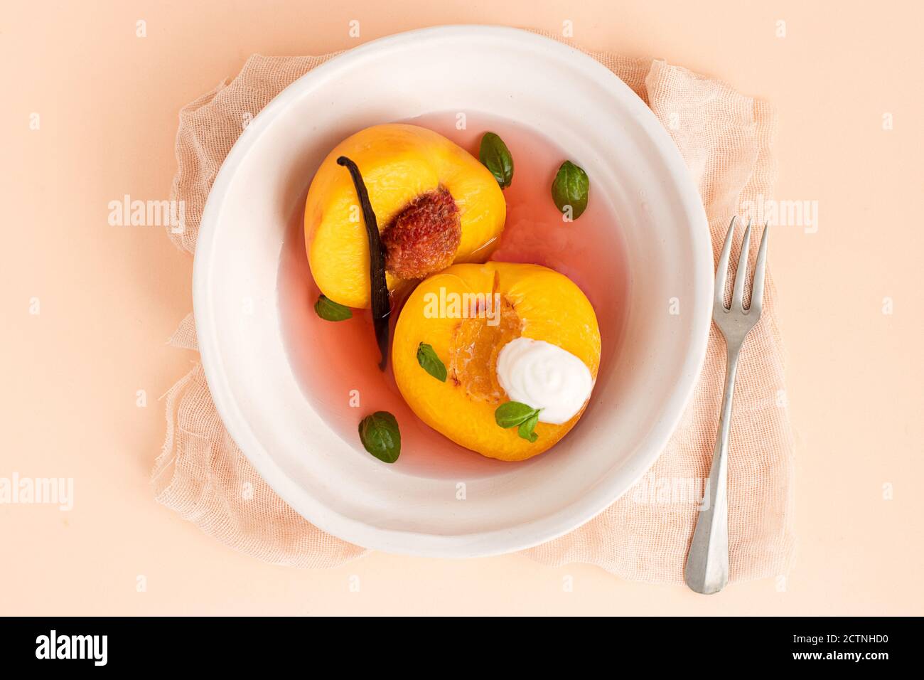Poached Peaches in white wine, vanilla and basil Stock Photo - Alamy