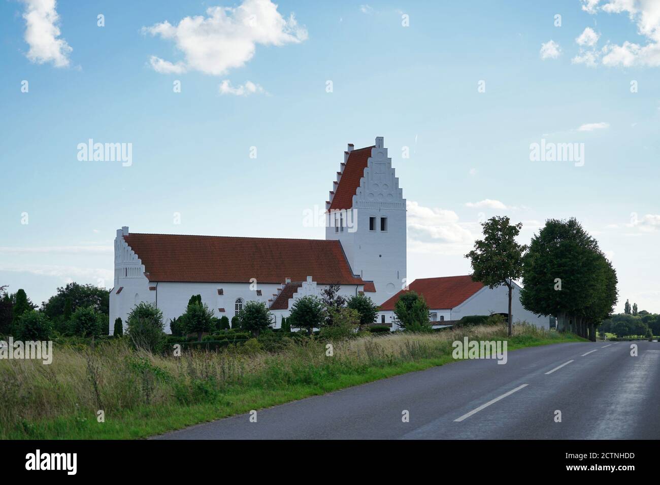 white church on Mon Island, blue sky, clouds, street Stock Photo - Alamy