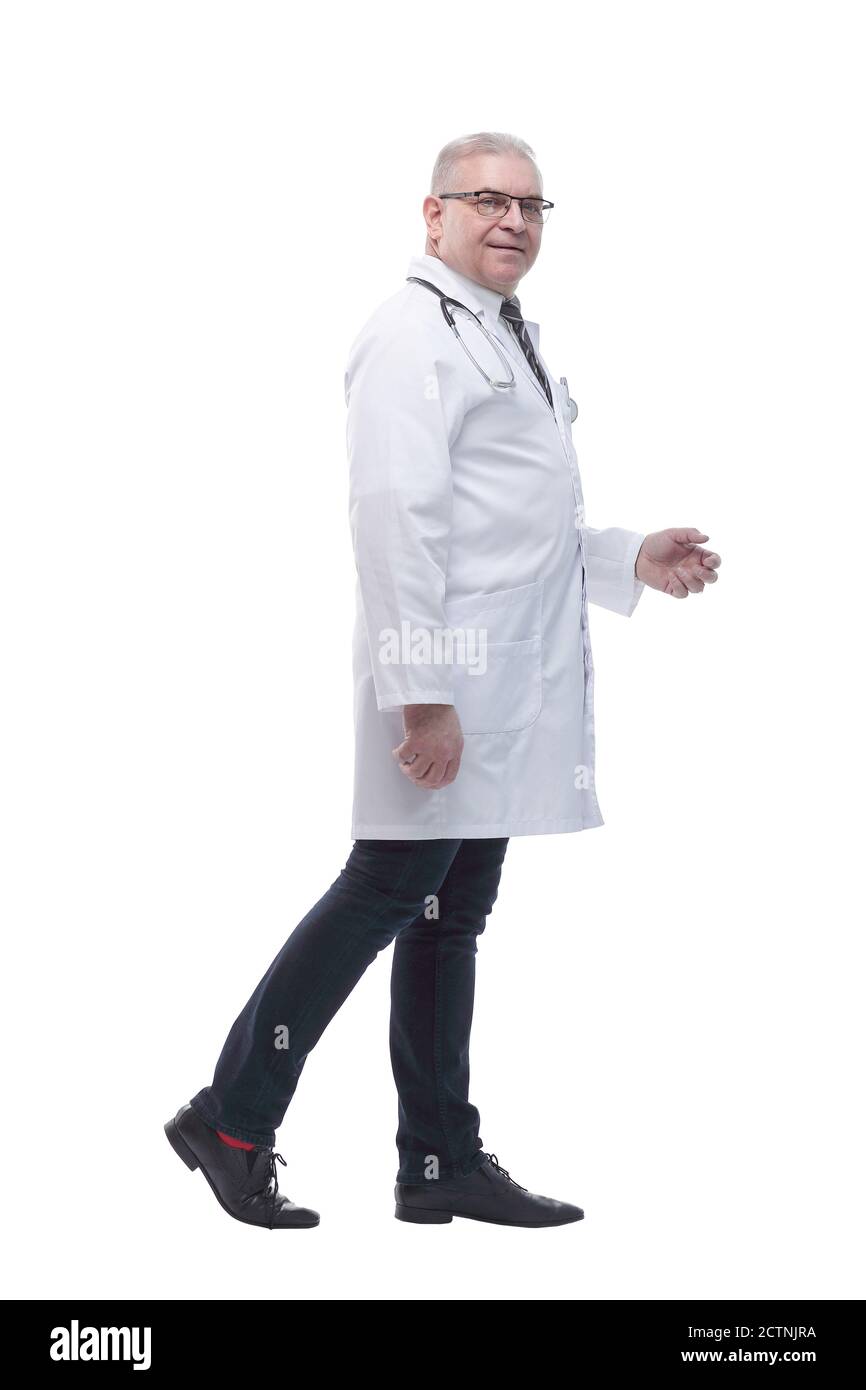 side view. smiling doctor walking to help Stock Photo - Alamy