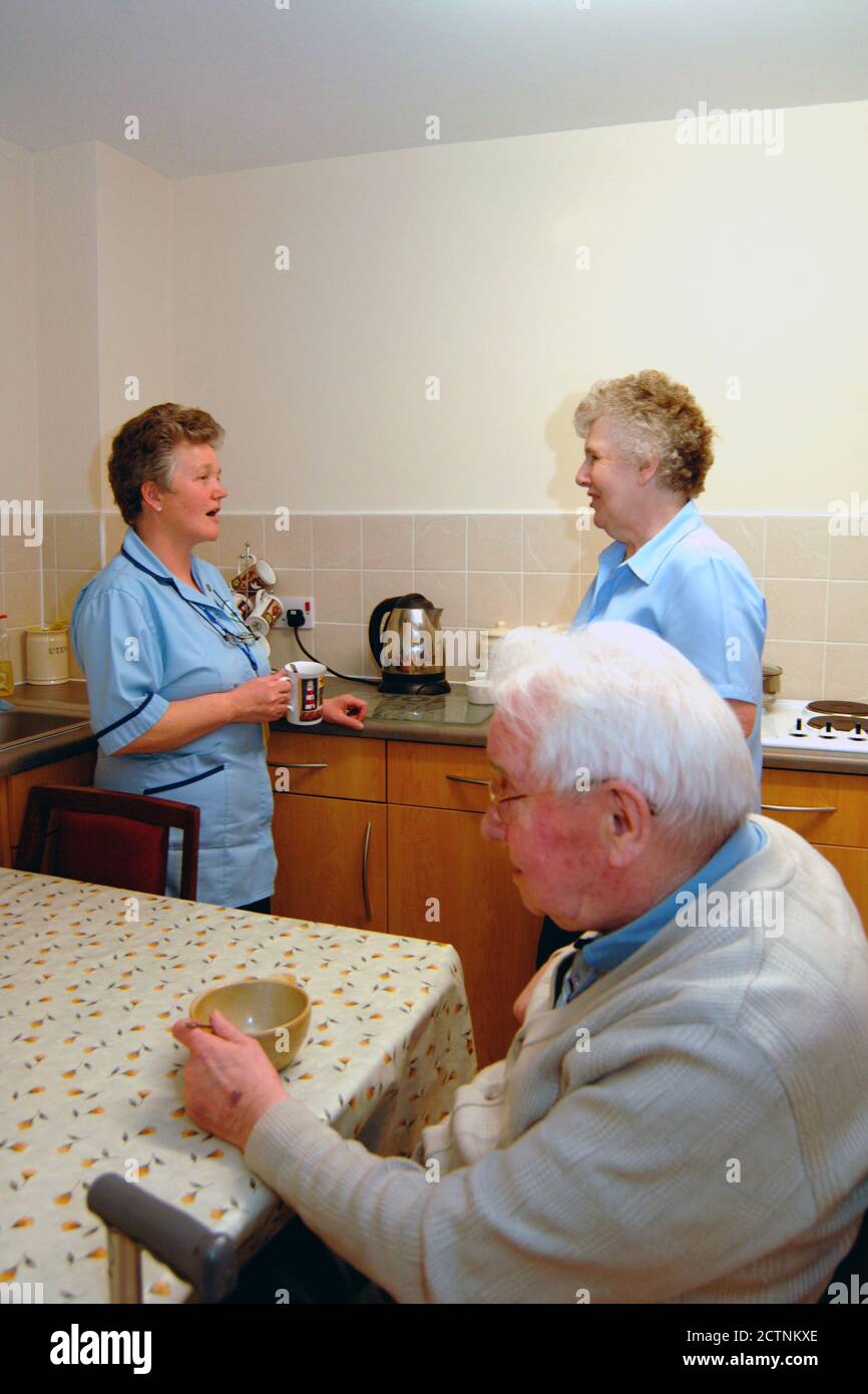 A Care Assistant makes tea for elderly couple living in new 'extra care ...