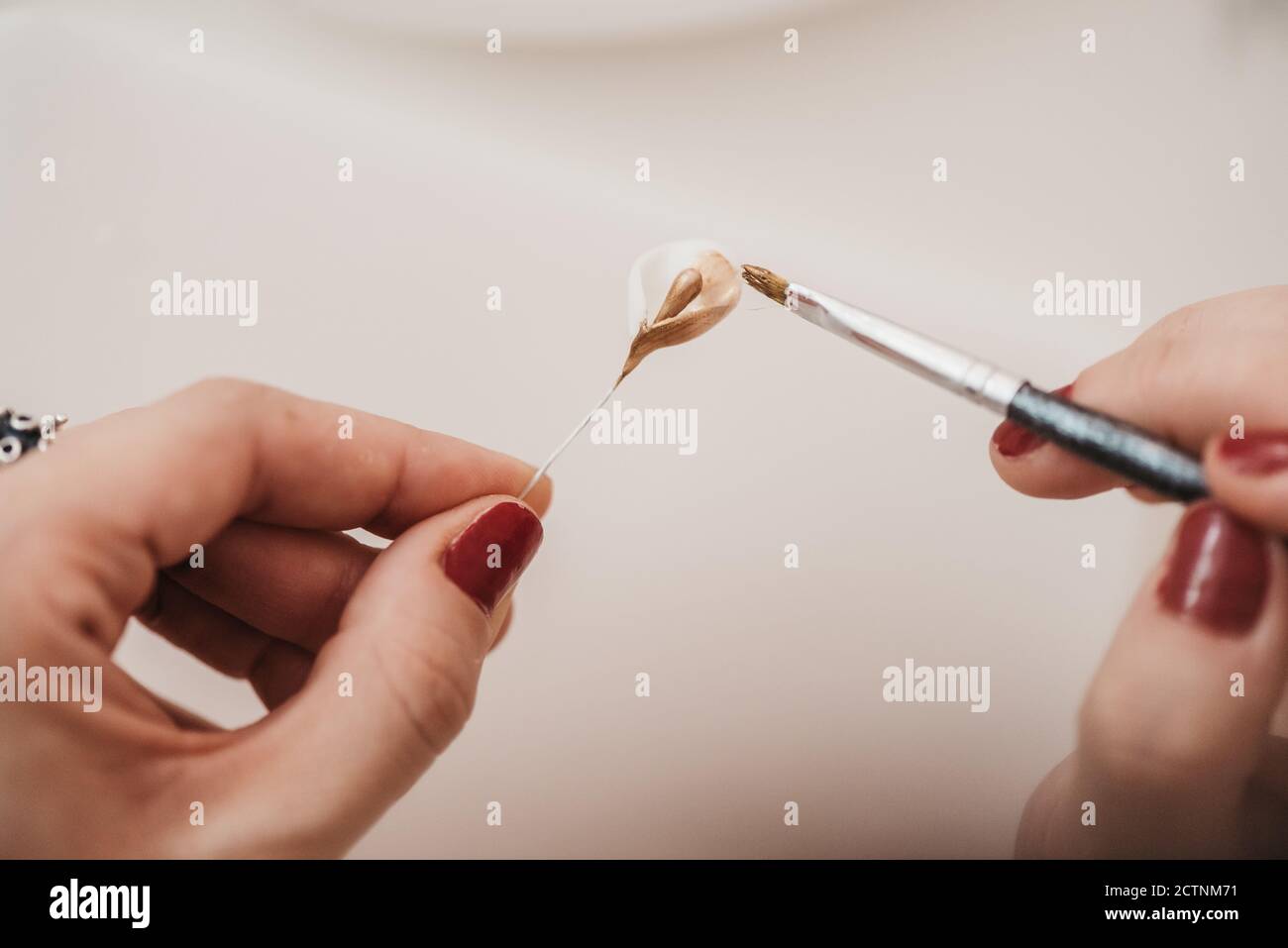 Applying body paint hi-res stock photography and images - Alamy