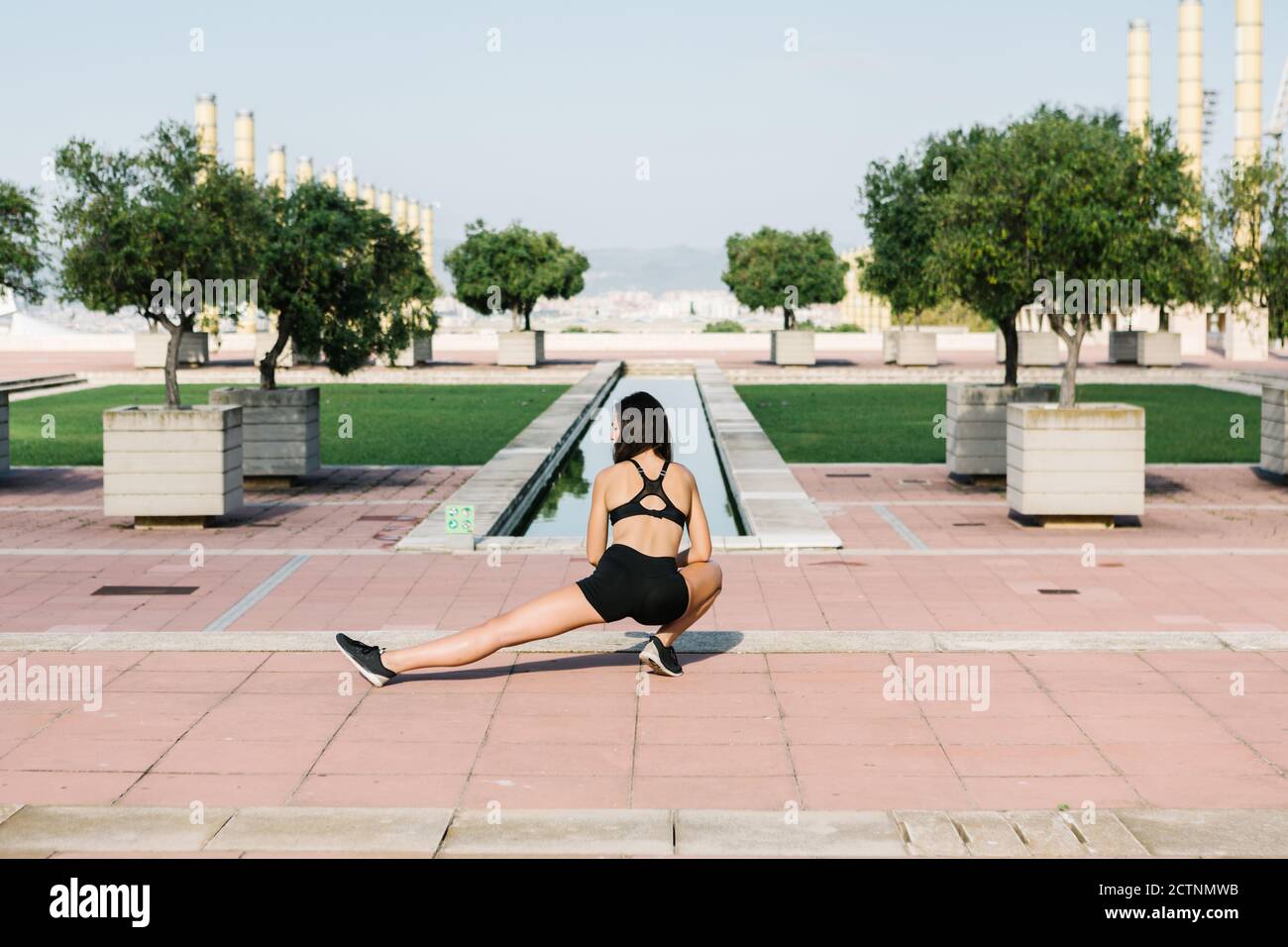 Full body back view of unrecognizable slim female in sports bra and ...
