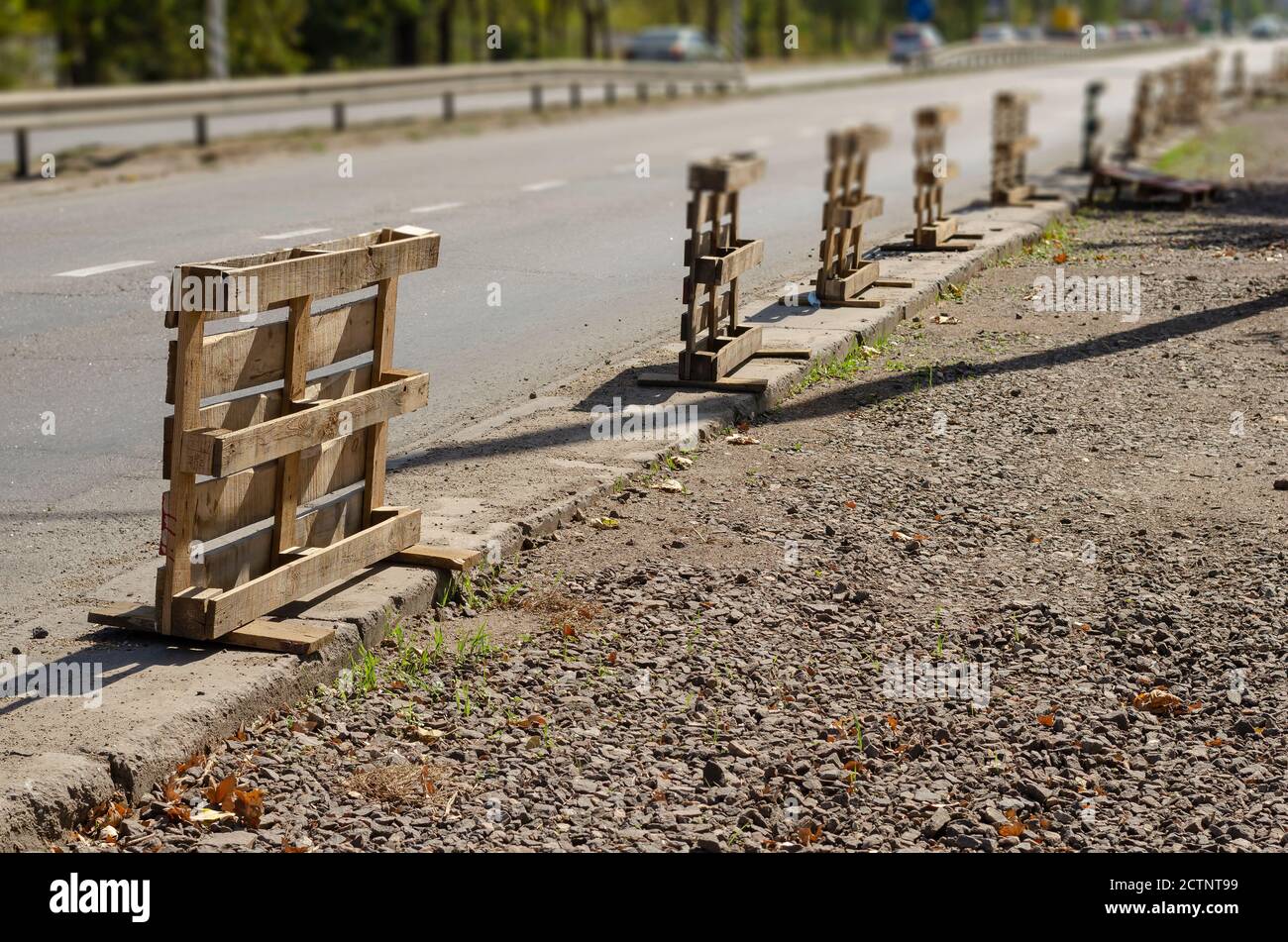 Line of Temporary Wooden Fences along the curb. Location of road works ...