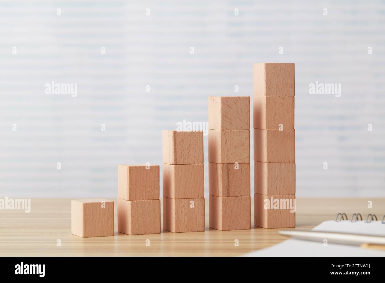 Wooden cubes on office desk Stock Photo - Alamy