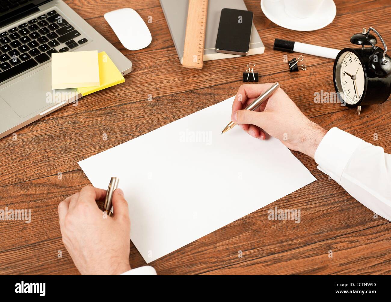 Man writing on paper Stock Photo - Alamy