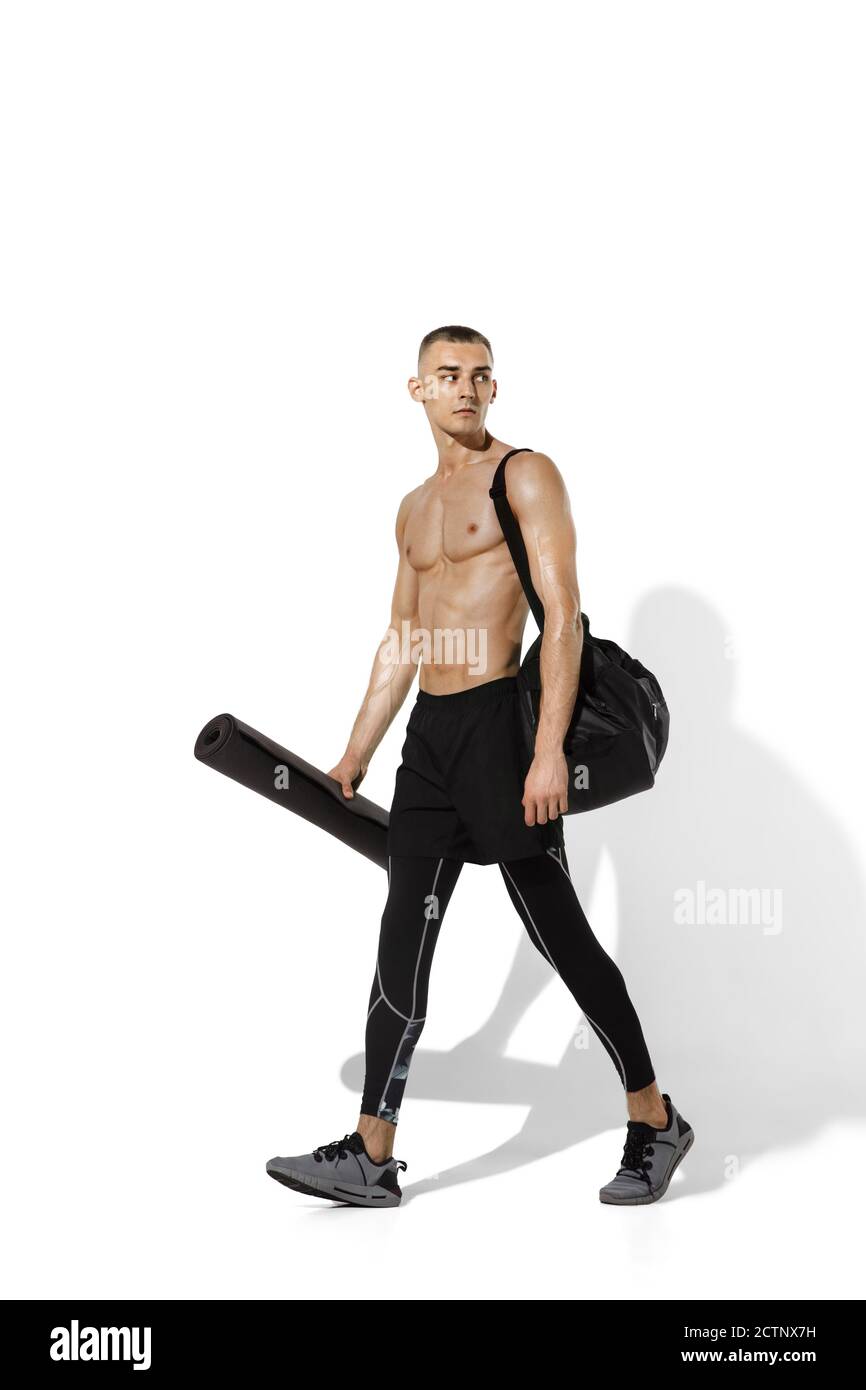 Before workout. Stylish young male athlete on white studio background ...
