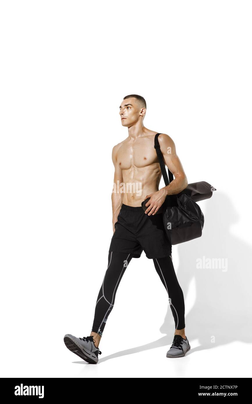 Before workout. Stylish young male athlete on white studio background ...