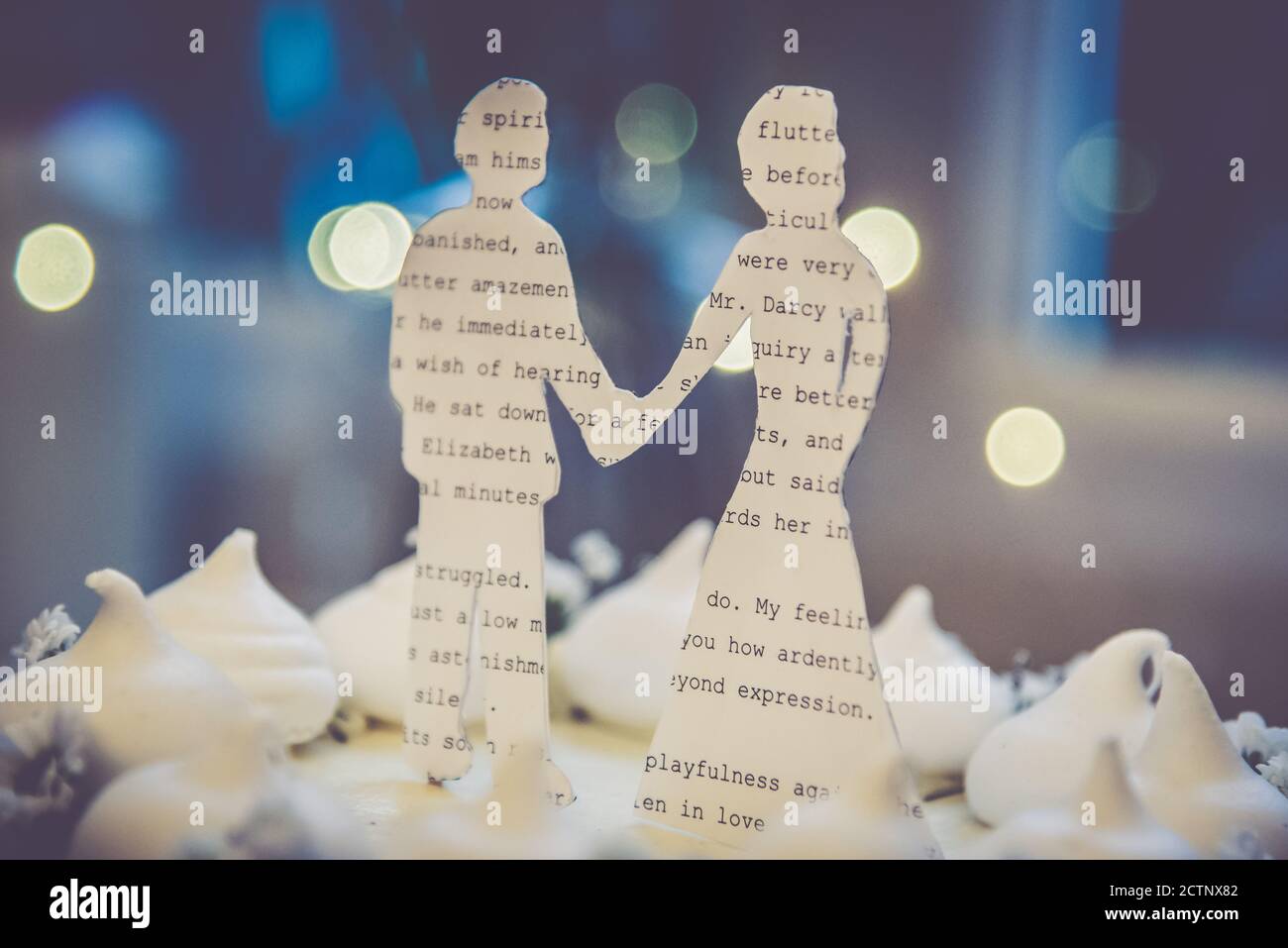 Cut out cake toppers from the couples favorite books Stock Photo - Alamy