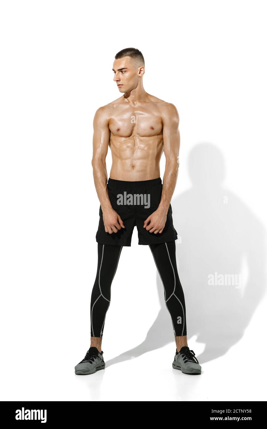 Posing. Stylish young male athlete practicing on white studio ...
