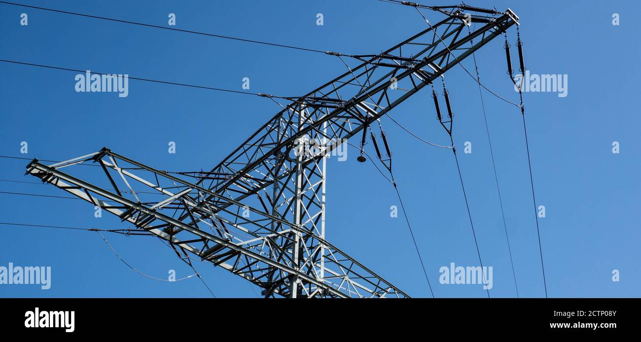 Panorama high voltage pylon isolated blue background Stock Photo - Alamy