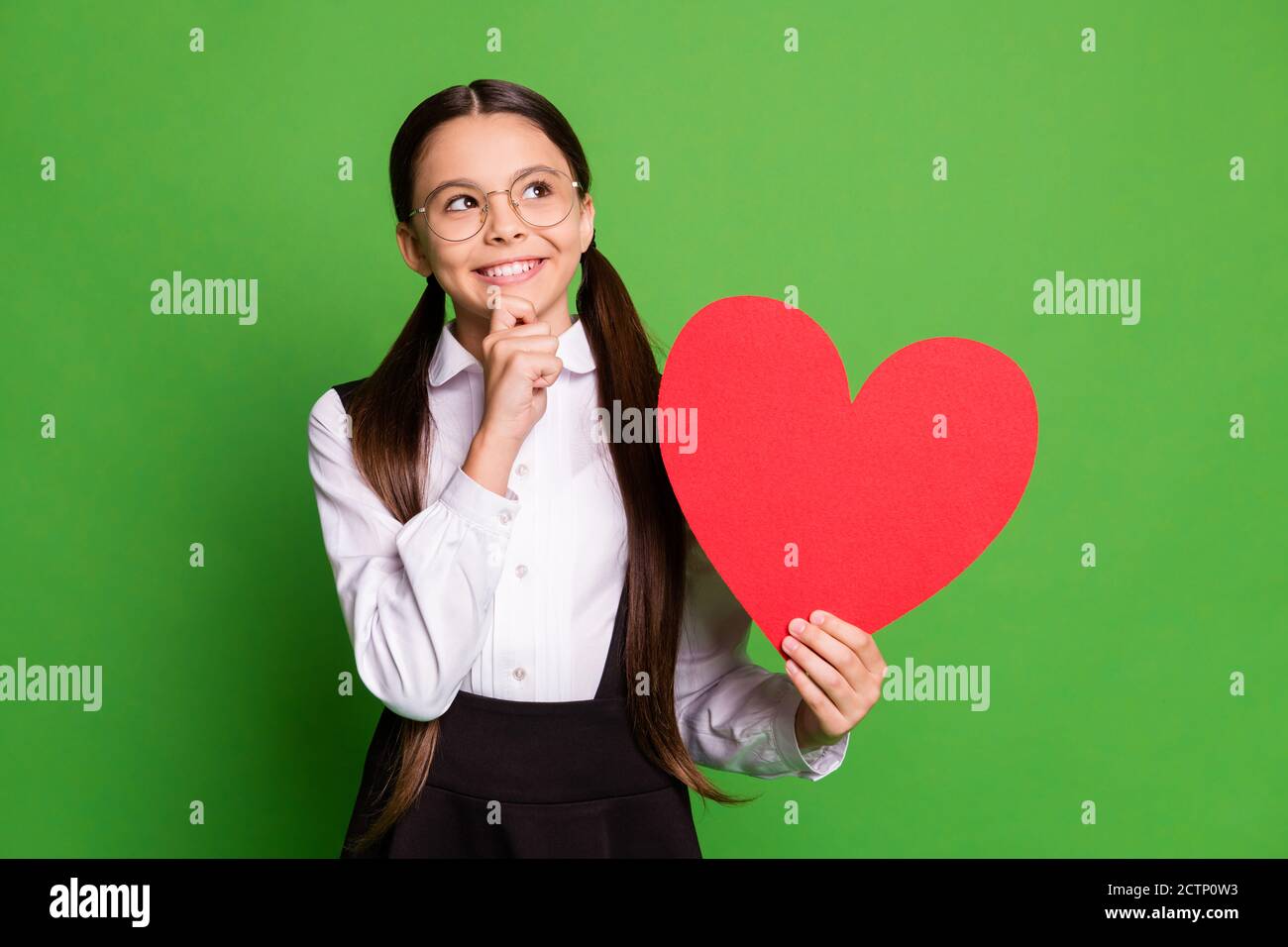 Photo of pretty cunning little schoolkid lady in front of blackboard ...