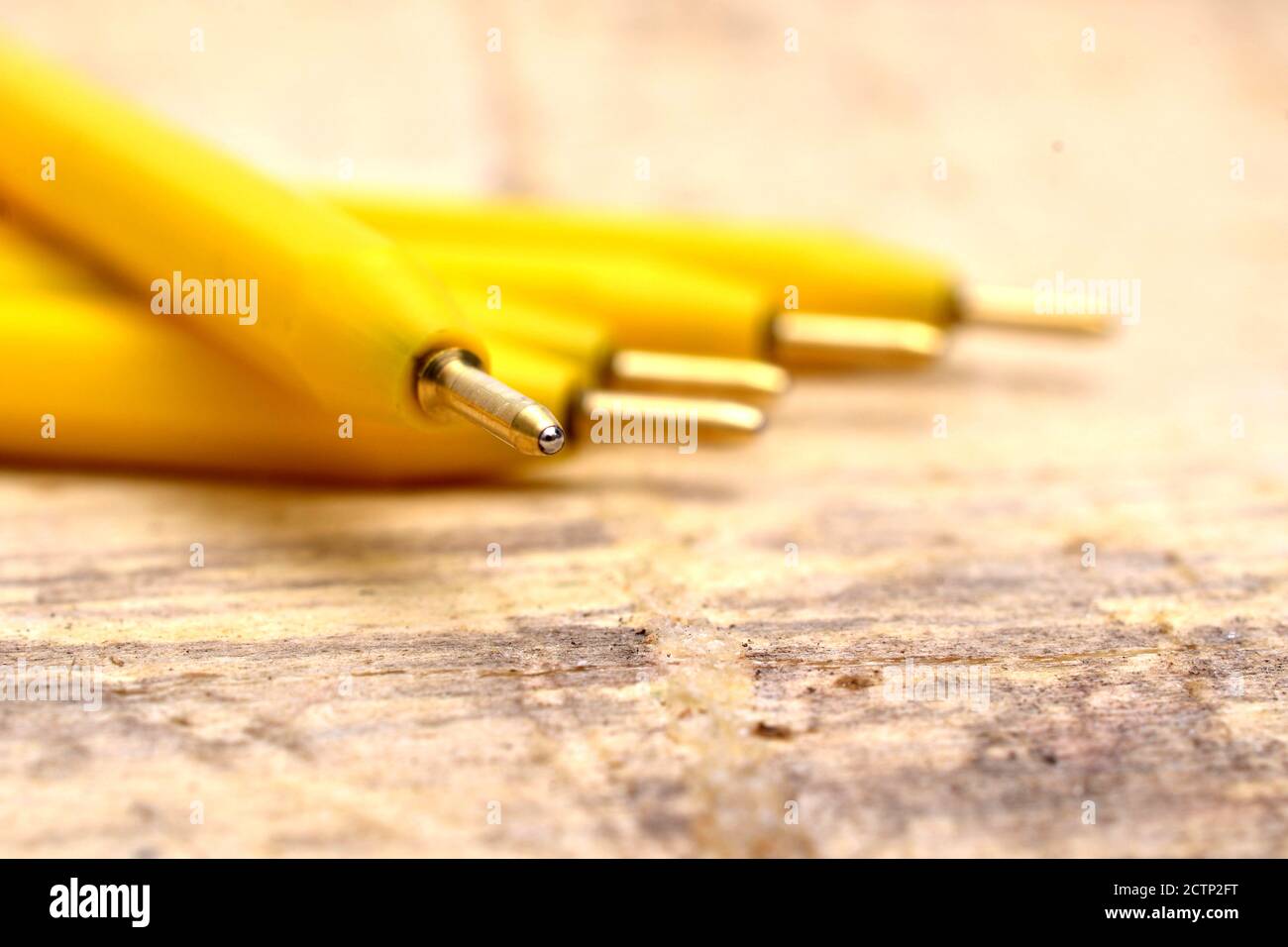 Yellow pen on wood background image Stock Photo - Alamy