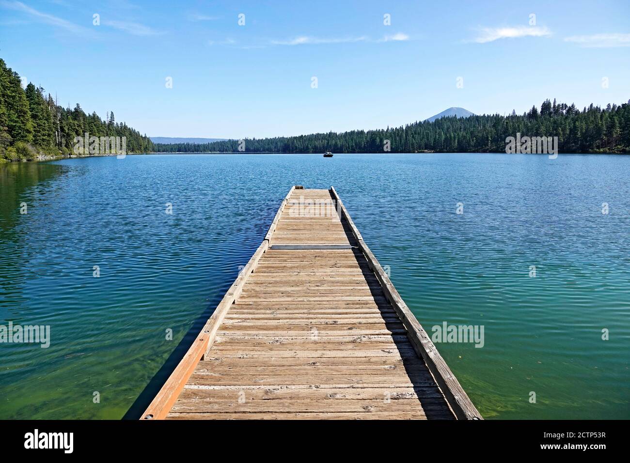 A long pier jutting out into Suttle Lake, a natural mountain lake in ...