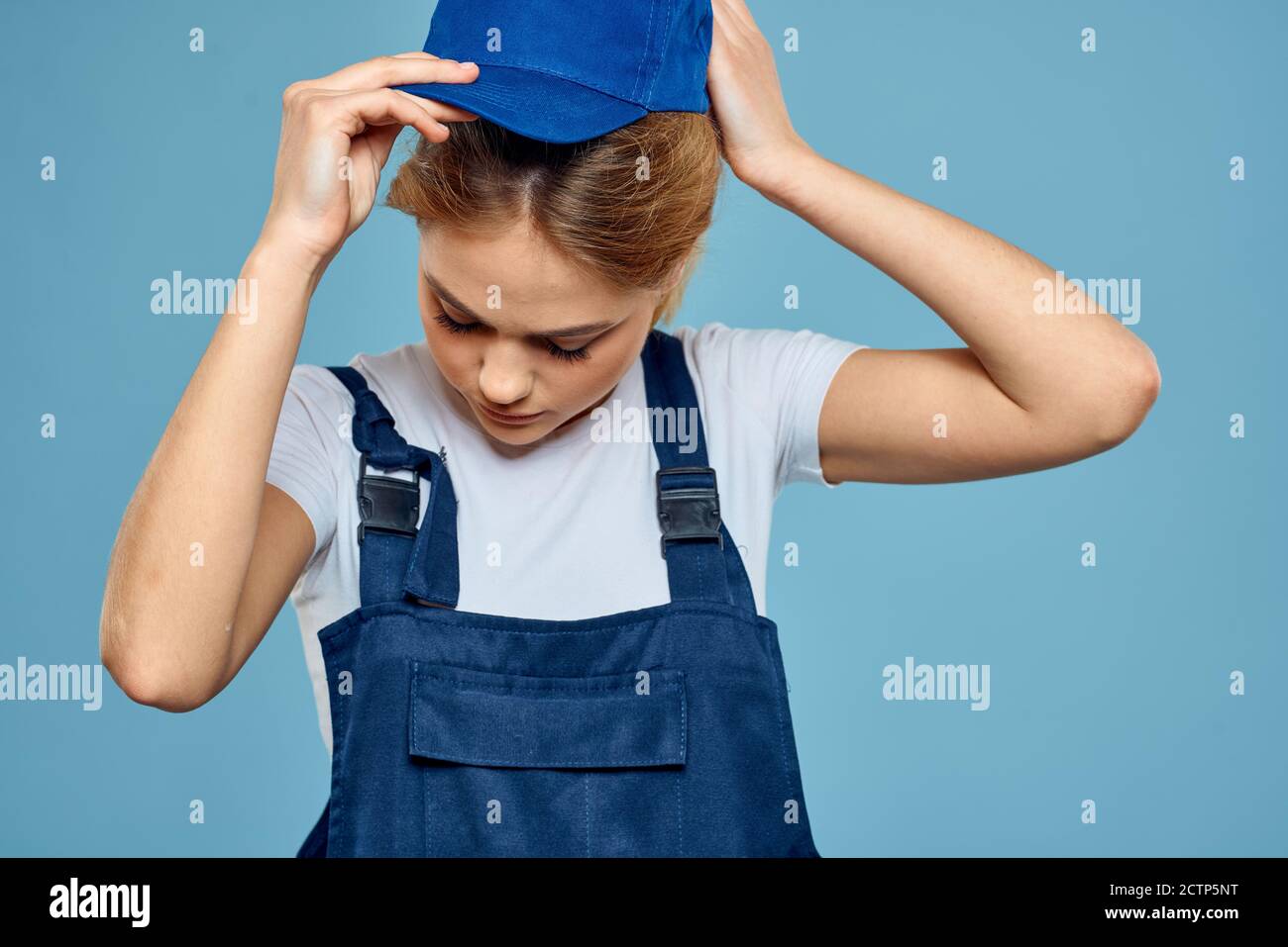Woman in work uniform blue cap carriage delivery service courier blue ...