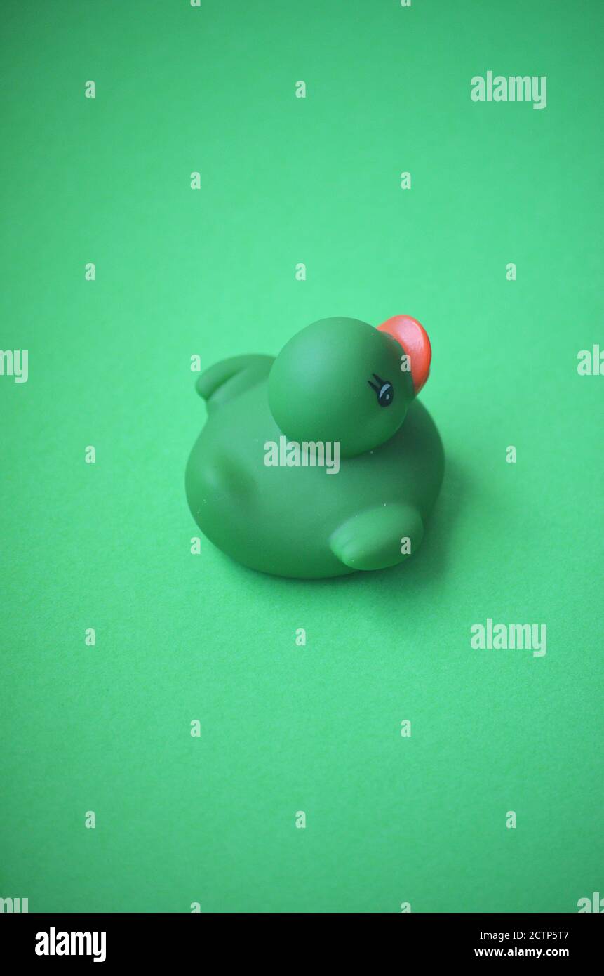 Isolated dark green toy rubber duck on a green background Stock Photo ...